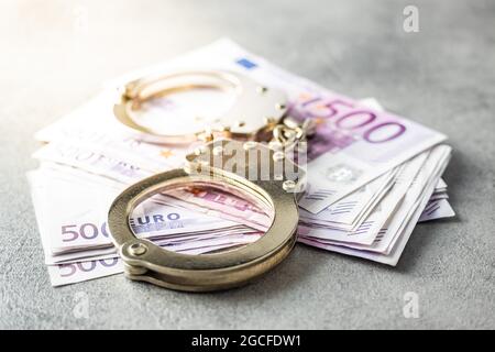 Euro banknotes and metal handcuffs, financial crime concept Stock Photo ...
