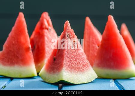 Fresh bright juicy triangular watermelon slices on blue background ...