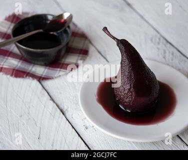 Sweet pear cooked with red wine, delicious homemade dessert Stock Photo ...