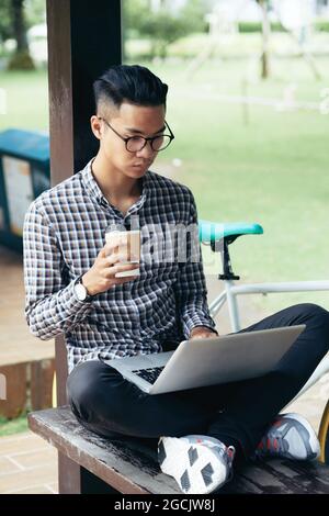 Pensive man checking programming code for errors when working on laptop from home Stock Photo ...