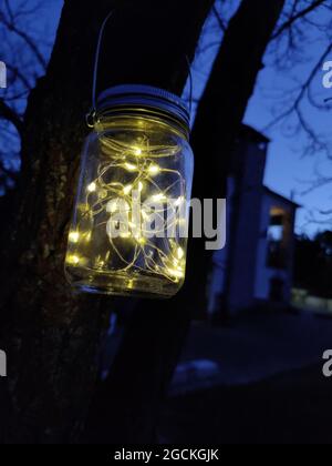 Festive hanging garlands with glowing light bulbs against the ...