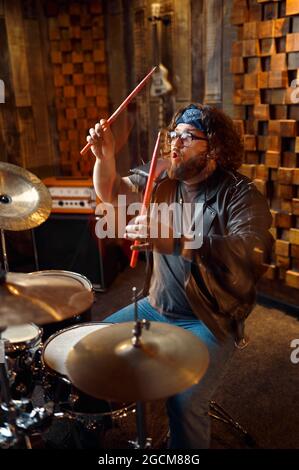 music band on repetition, drummer standing in front and holding sticks ...
