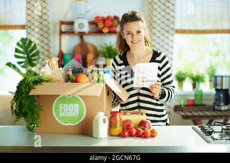 Food delivery. happy modern middle aged housewife with food box and ...