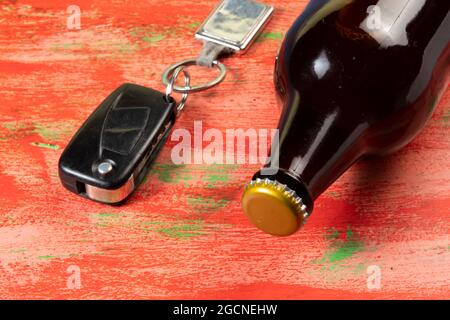 alcohol abuse and danger in car driving symbolized by key and bottle ...