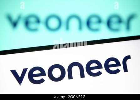 In this photo illustration a Veoneer logo is seen on a smartphone and a ...