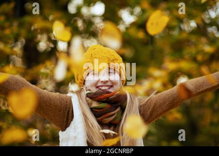 happy child girl throws autumn leaves and laughs outdoors - fall and ...