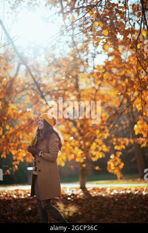 Hello november. smiling young woman in scarf with leather gloves ...