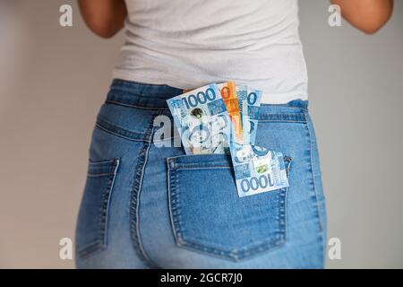 Philippines Peso in a female jeans pocket. Philippine pesos notes stuck ...
