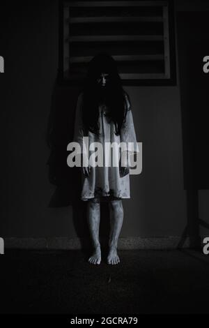 a scary looking girl possessed by a demon Stock Photo - Alamy