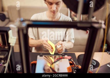 Young man set up 3d printer at home Stock Photo - Alamy
