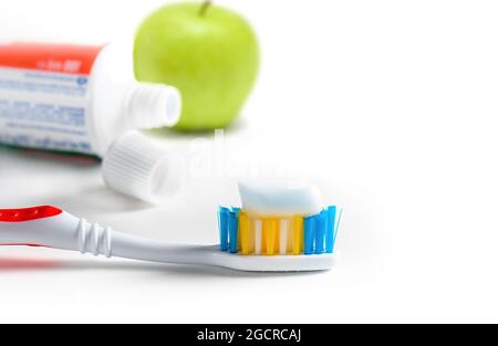 A tube of toothpaste, with white, green and red striped toothpaste on a ...