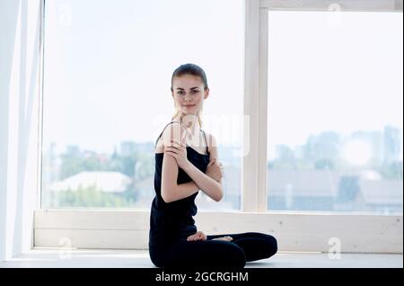 woman meditates on windowsill near window workout exercise Stock Photo ...