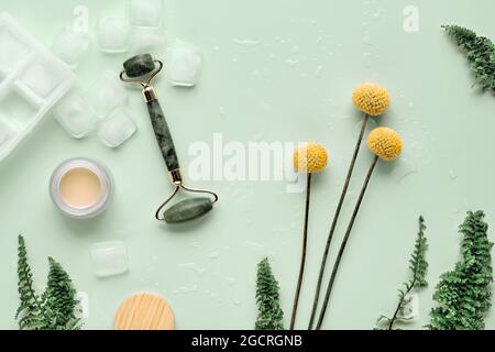 Green jade face roller with ice , cream and essential oil. Mint green ...