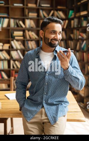 Male Entrepreneur Using Voice Search On Phone Sitting In Office Stock ...