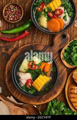 Chilean meat soup with pampkin, corn, fresh coriander and potatoes on ...