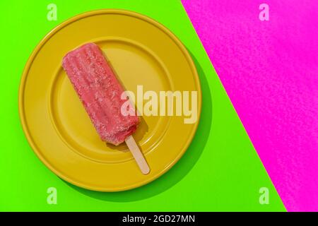 Strawberry fruity pink icepop on modern stylized neon pink background ...