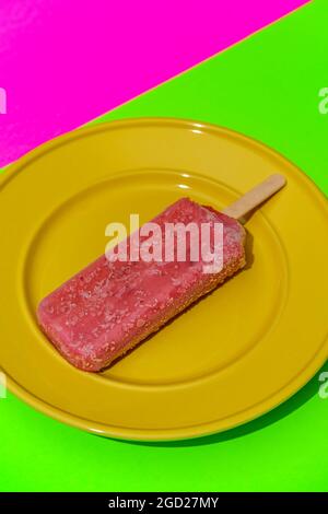 Strawberry fruity pink icepop on modern stylized neon pink background ...