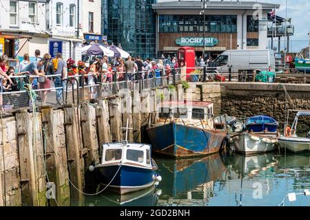 Brixham, UK. Tuesday 10 August 2021. Good weather fills the town of ...