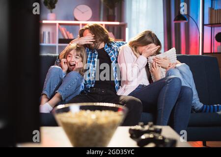 Scared kids watching horror movie Stock Photo - Alamy