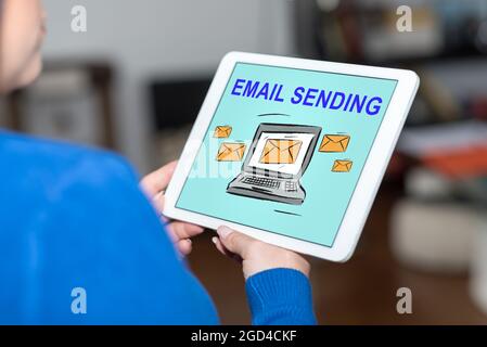 Tablet screen displaying an email sending concept Stock Photo - Alamy