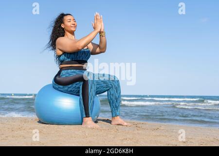 overweight woman with ball on beach Stock Photo - Alamy