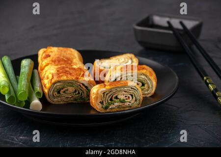 Japanese kitchen. Tamagoyaki - Japanese omelet, rolled several layers ...