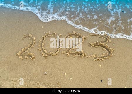 2023 year written on sandy beach sea Stock Photo - Alamy