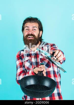just smell it. man holding frying pan.. male chef kitchener cooking ...