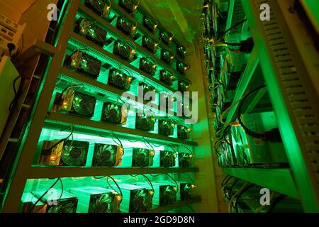 Bitcoin miners in large farm. ASIC mining equipment on stand racks mine ...