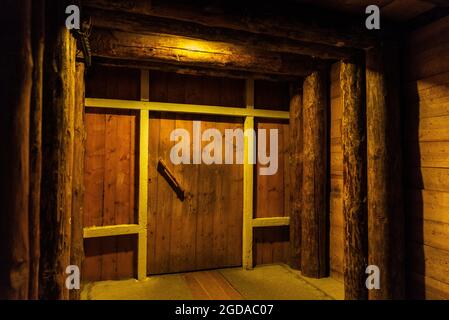 Old corridor propped up with wooden beams and a closed door in the ...