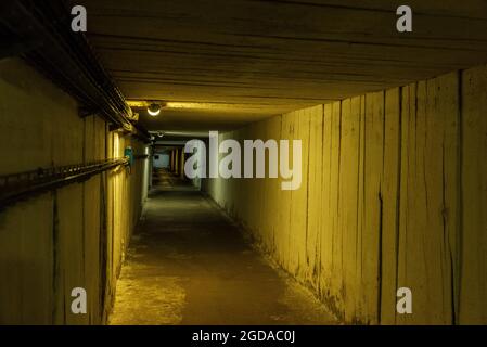 Old corridor propped up with wooden beams and a closed door in the ...