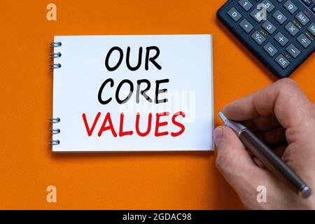 Our core values symbol. Businessman writing words 'Our core values ...