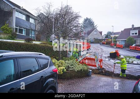 Digging up existing pavement for new cabling, laying, broadband ...