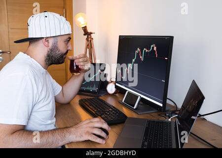 Young man watching stock market on laptop Stock Photo - Alamy