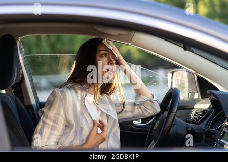 Woman driver being hot during heat wave in car, suffering from hot ...