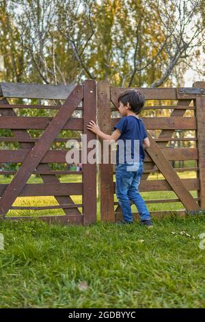 An open wooden garden gate in an English country garden showing a view ...