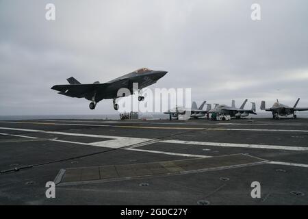 Various aircraft on final approach to a aircraft carrier at sea Stock ...