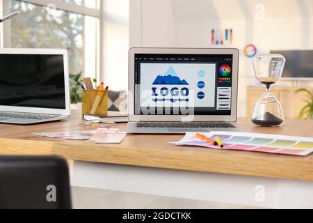 Stylish workplace of graphic designer with laptops in office Stock ...