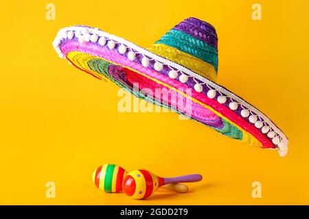 Mexican maracas and sombrero on color background Stock Photo - Alamy