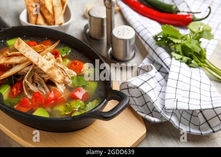 Baking dish with tasty Sopa de Lima soup on table, closeup Stock Photo ...
