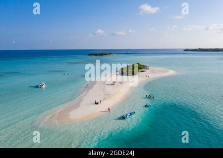 Aerial view of travelers on a small sandy island in the Indian Ocean ...