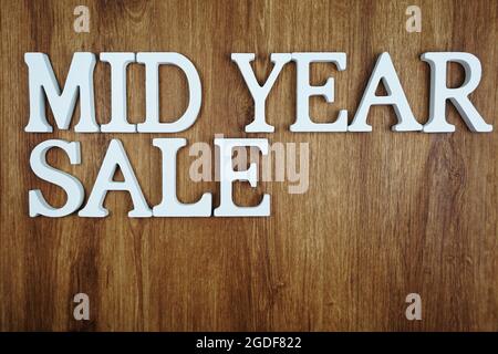 Mid Year Sale alphabet letters decorate with LED cotton balls on blue ...