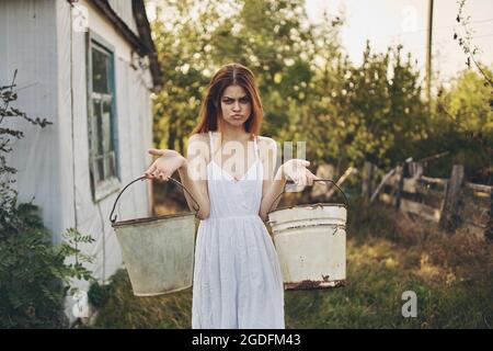 pretty woman with buckets in hand nature Lifestyle Stock Photo - Alamy