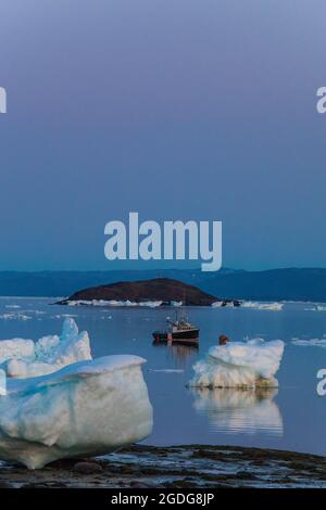 Small boat moored among large chunks of sea ice, Iqaluit, Canada Stock ...
