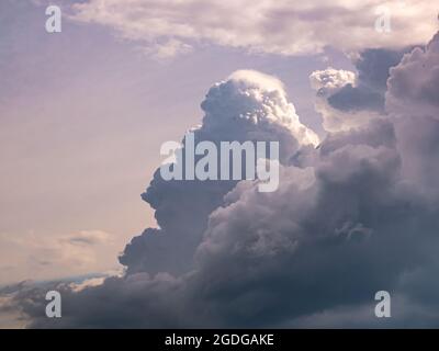 Massive white cumulus cloud formation rising dramatically against a ...