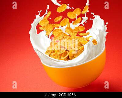 cornflakes falling into bowl with milk splashes isolated on white Stock ...