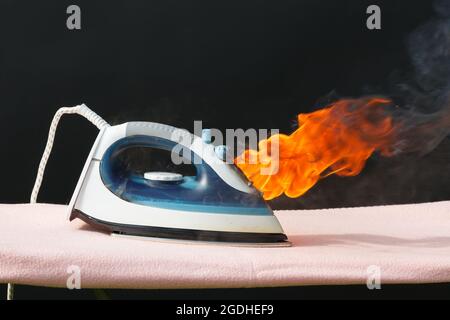 Iron in flames of fire, faulty wiring, cause of fire Stock Photo - Alamy