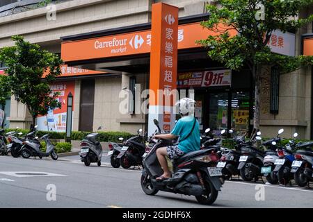 A person rides a scooter past the New York Stock Exchange, which is ...