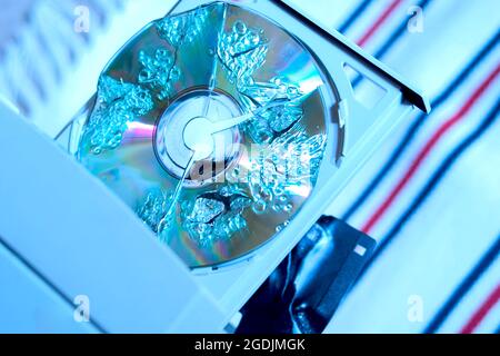 loss of data, melted DVD in a DVD drive Stock Photo - Alamy