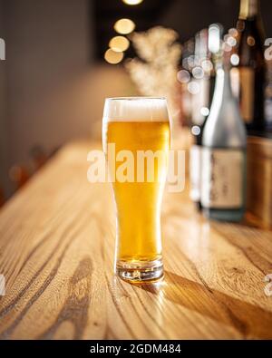 Glass with beer desk Stock Photo - Alamy